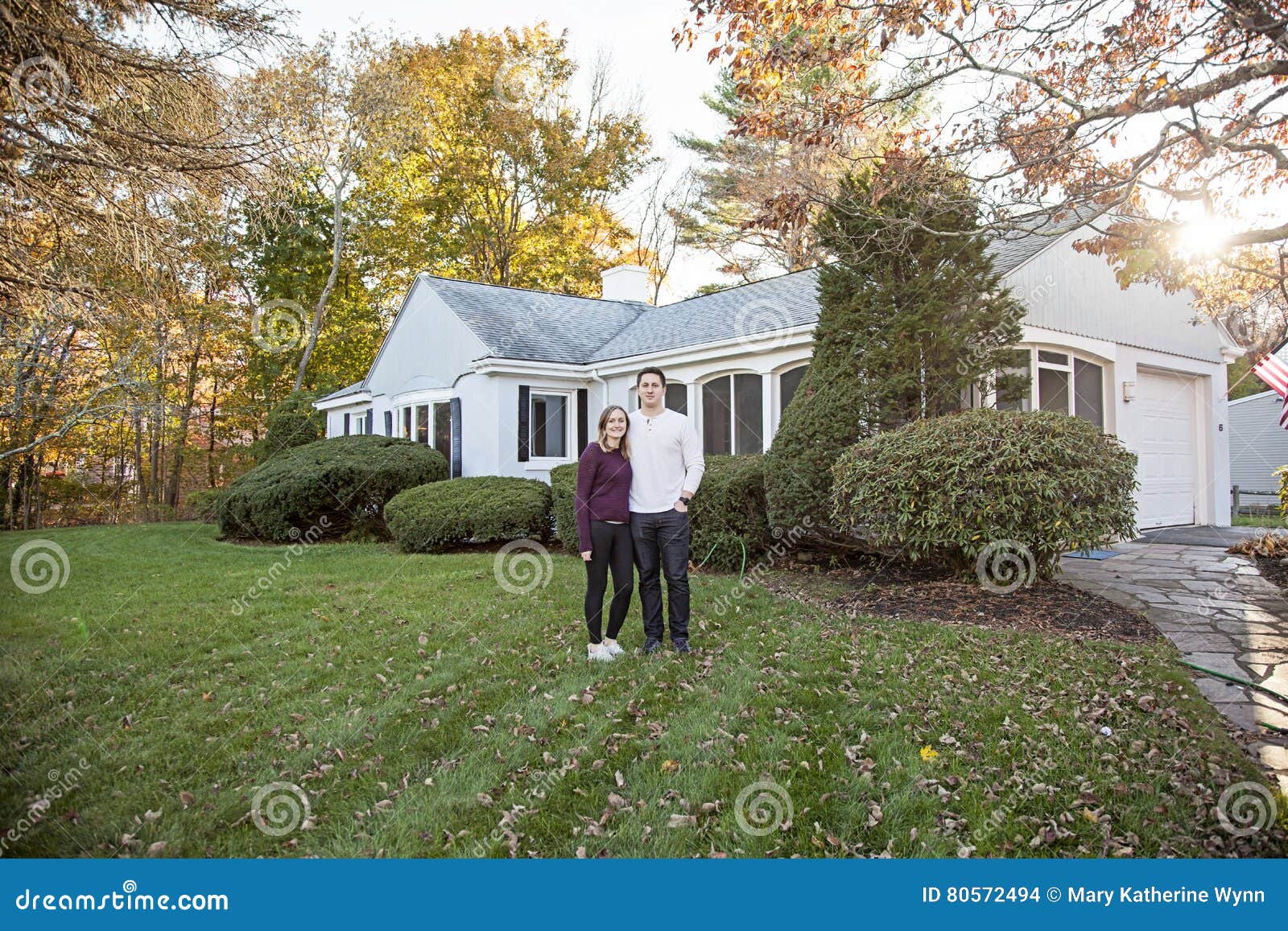 Couple Standing in Yard in Front of House Stock Photo - Image of style ...