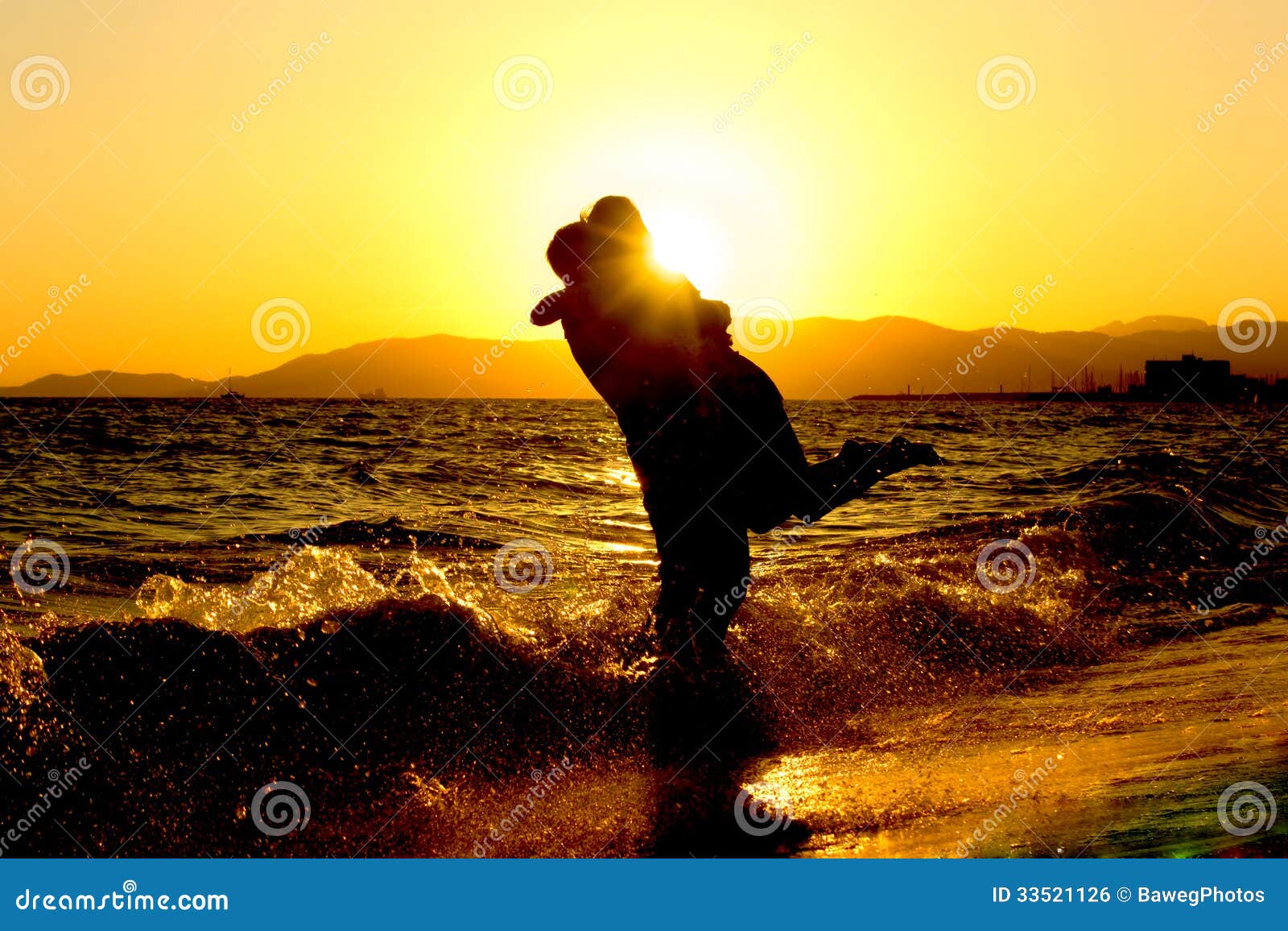 Couple in front of sunset stock photo. Image of jump - 33521126