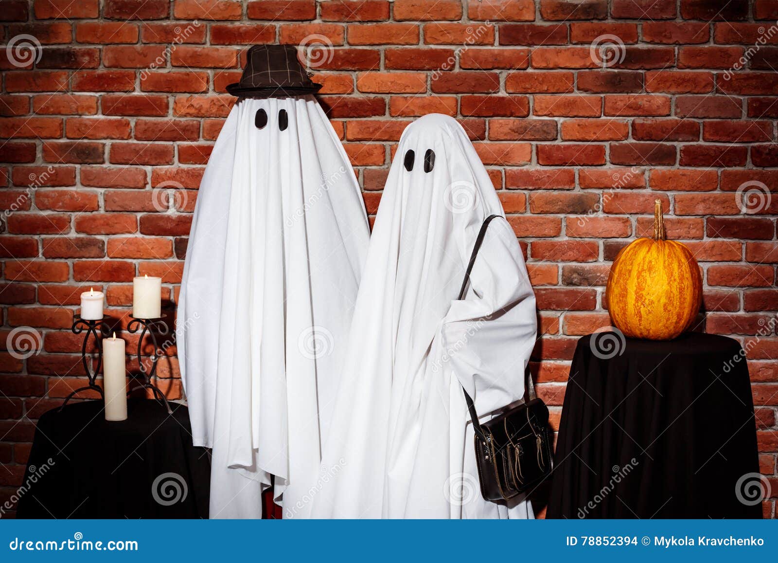 Couple Of Ghosts Posing Over Brick Background. Halloween Party. Stock ...