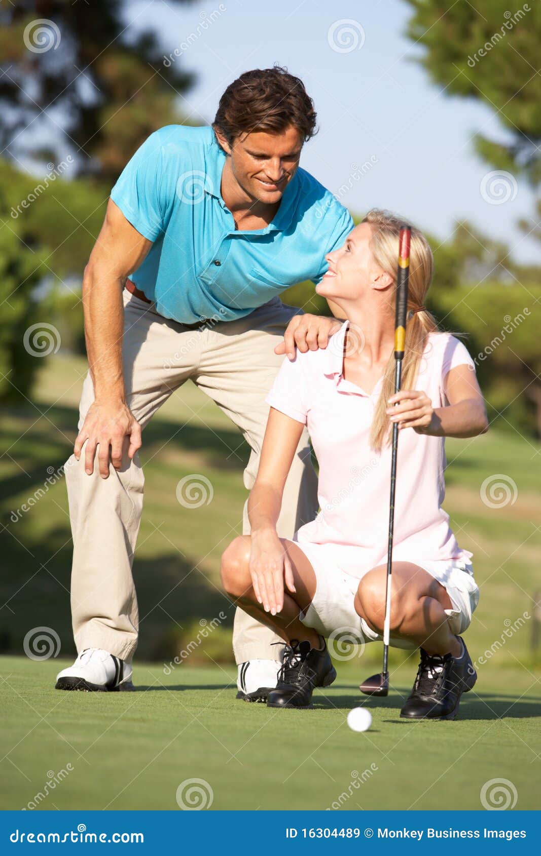 Couple Golfing on Golf Course Stock Image - Image of pastime, hobby ...