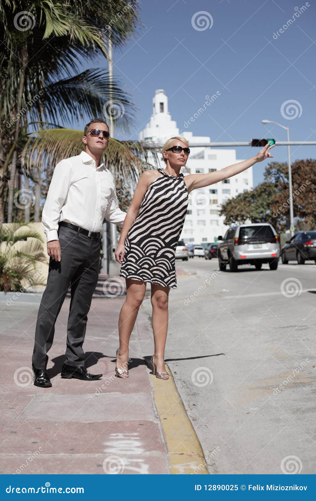 Couple hailing a taxi cab stock image. Image of hailing - 12890025