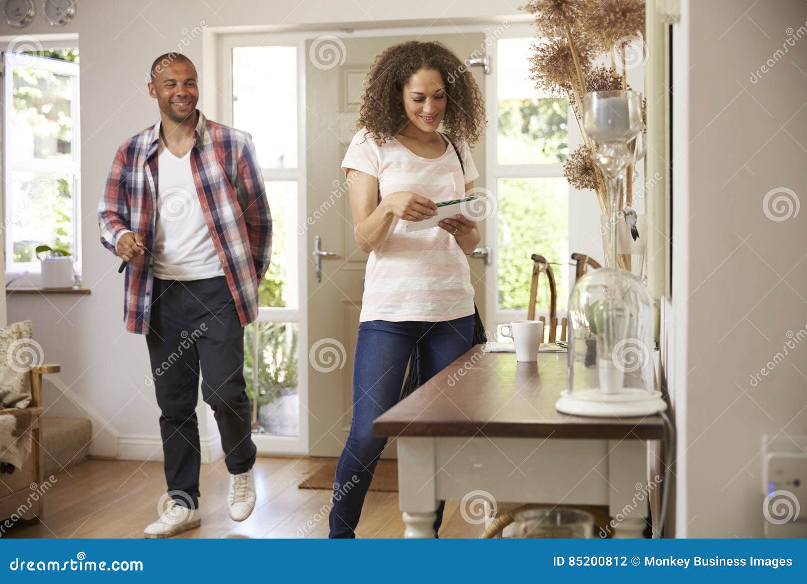 Couple in Hallway Returning Home Together Stock Photo - Image of mixed ...