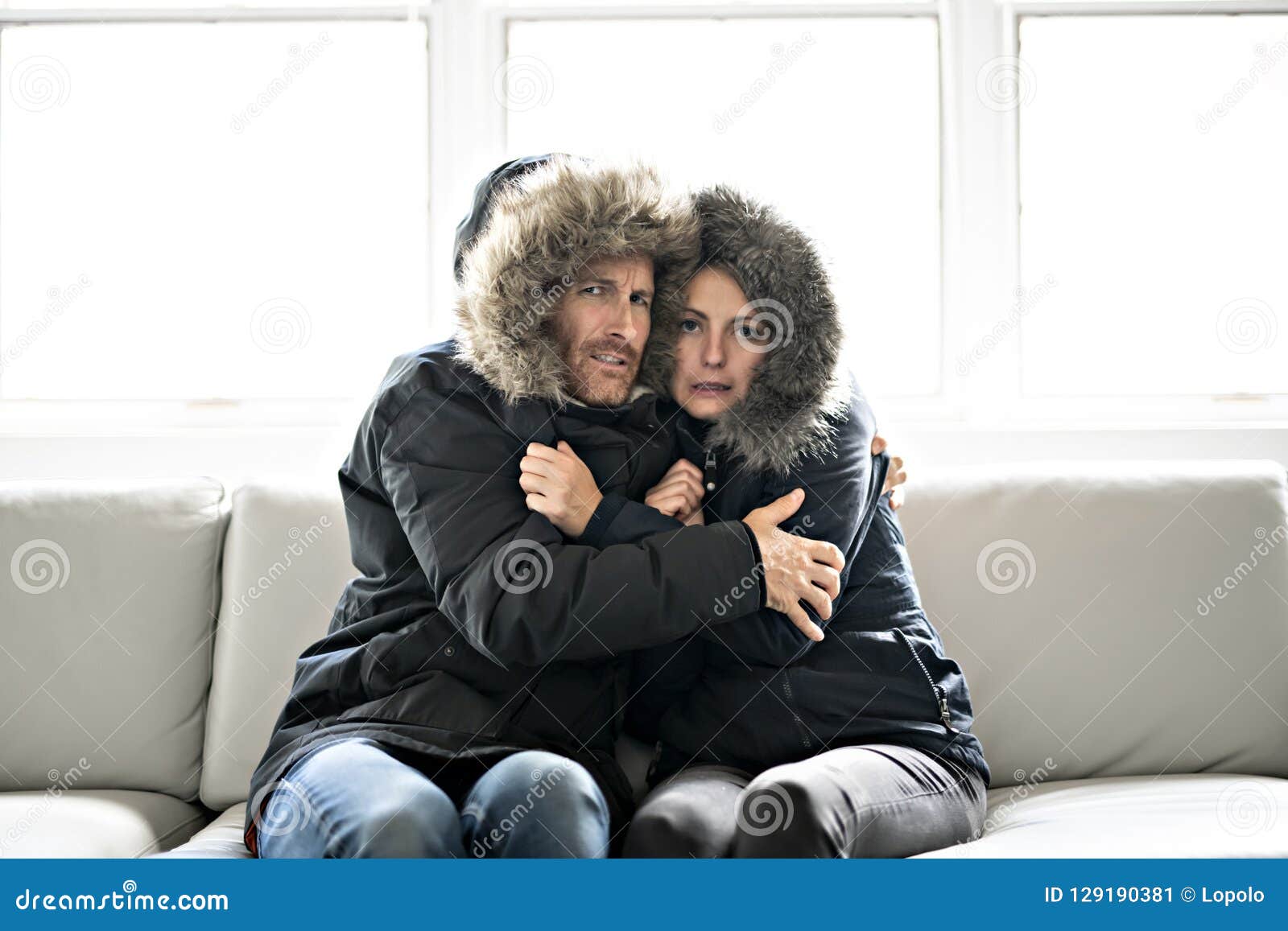 Couple Have Cold on the Sofa at Home with Winter Coat Stock Image ...