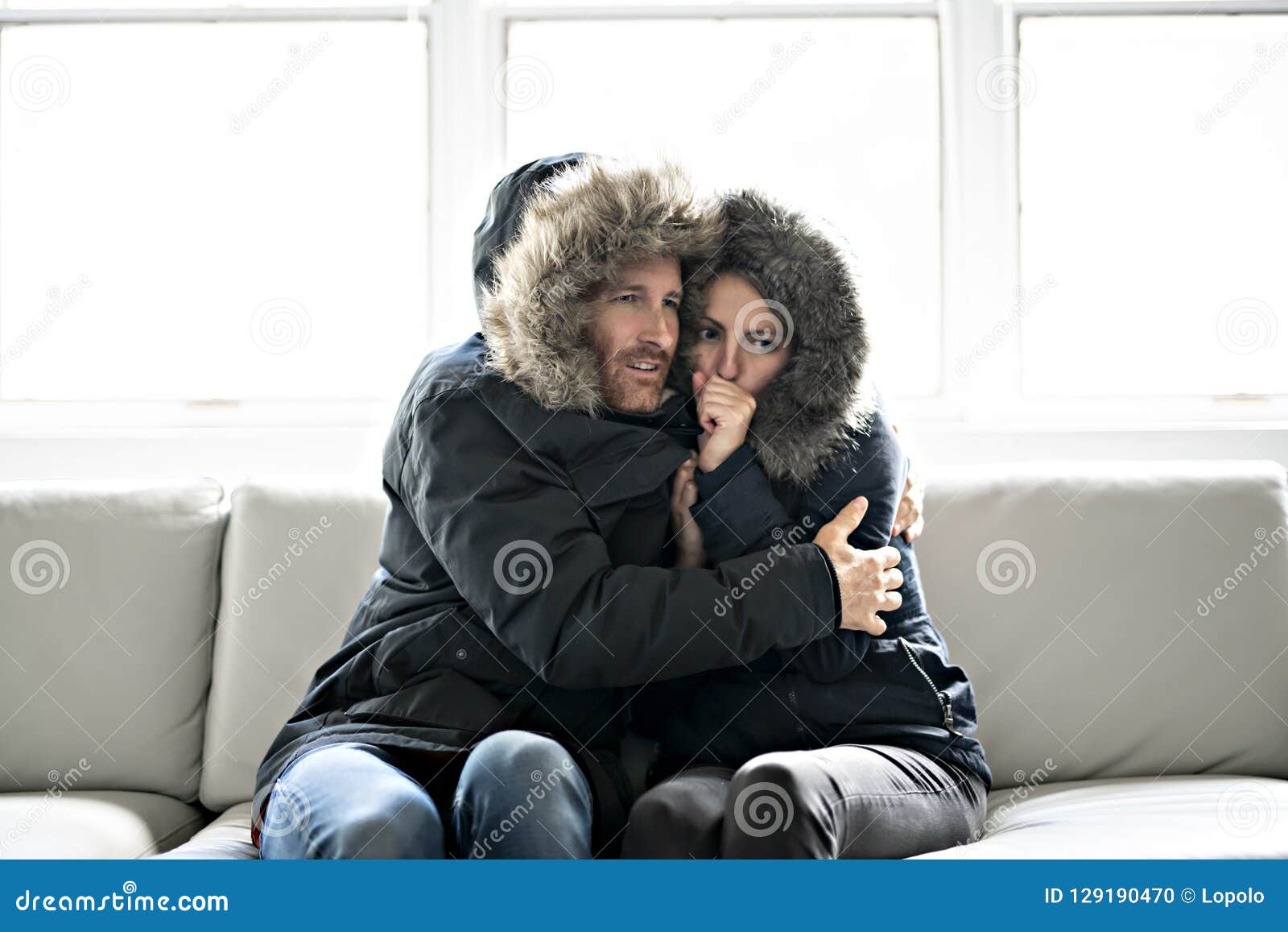 Couple Have Cold on the Sofa at Home with Winter Coat Stock Photo ...