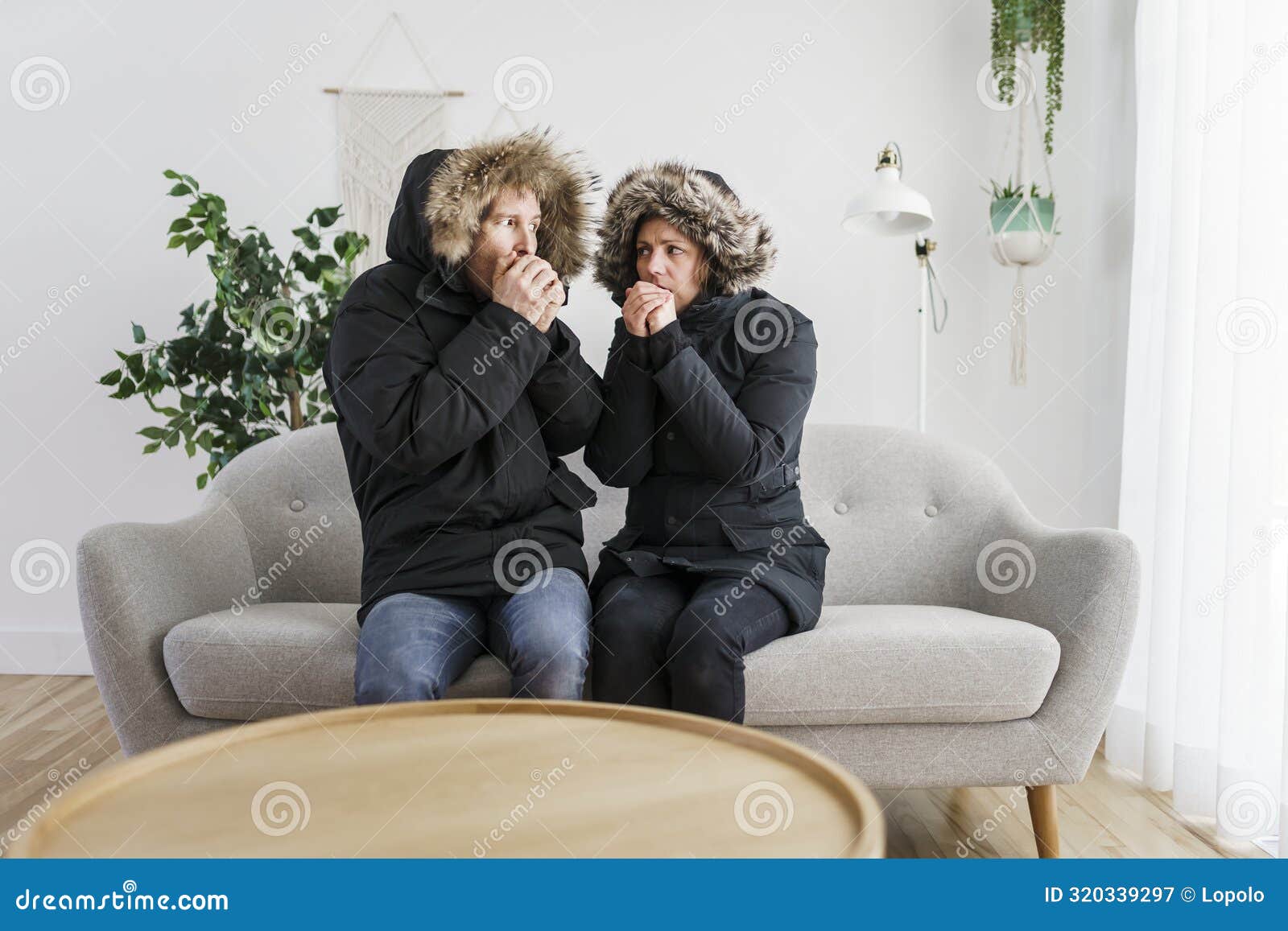 Couple Have Cold on the Sofa at Home with Winter Coat Stock Image ...