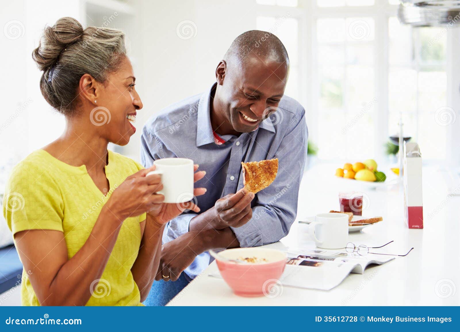 Couple Having Breakfast and Reading Magazine in Kitchen Stock Photo ...