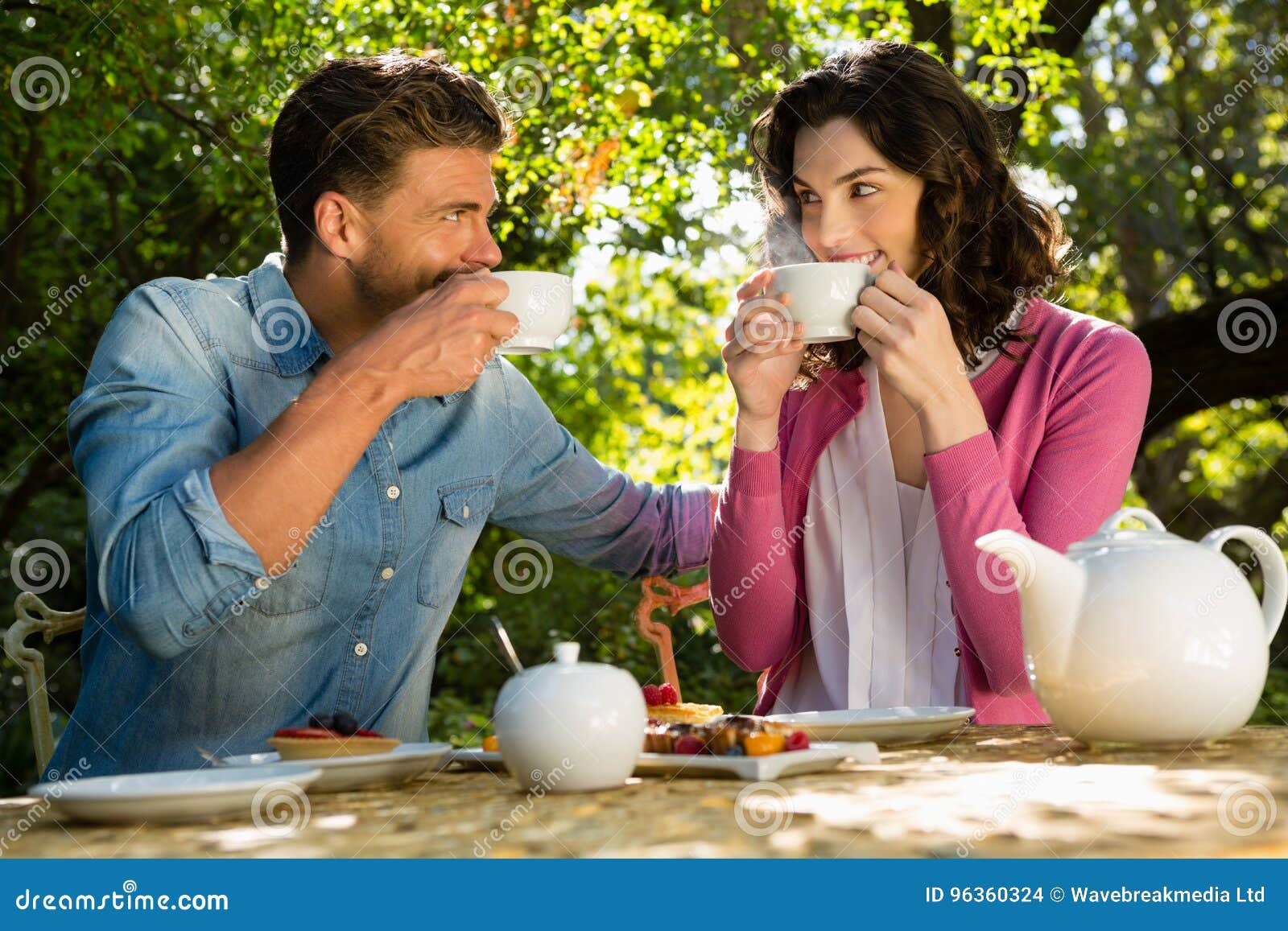 Couple Having Cup of Tea in Garden Stock Photo - Image of people ...