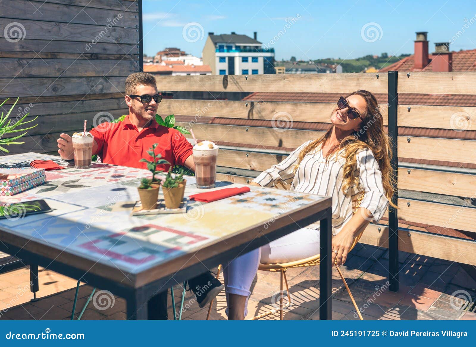 Couple Having a Drink on a Terrace Stock Image - Image of laughing ...
