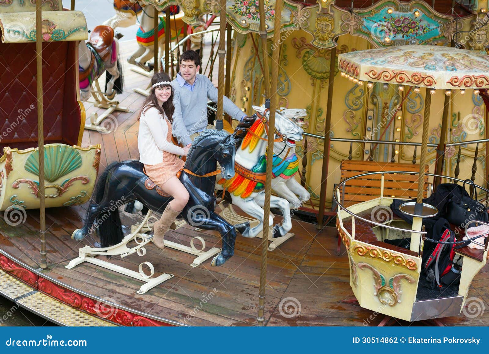 Couple Having Fun on a Merry-go-round Stock Photo - Image of family ...
