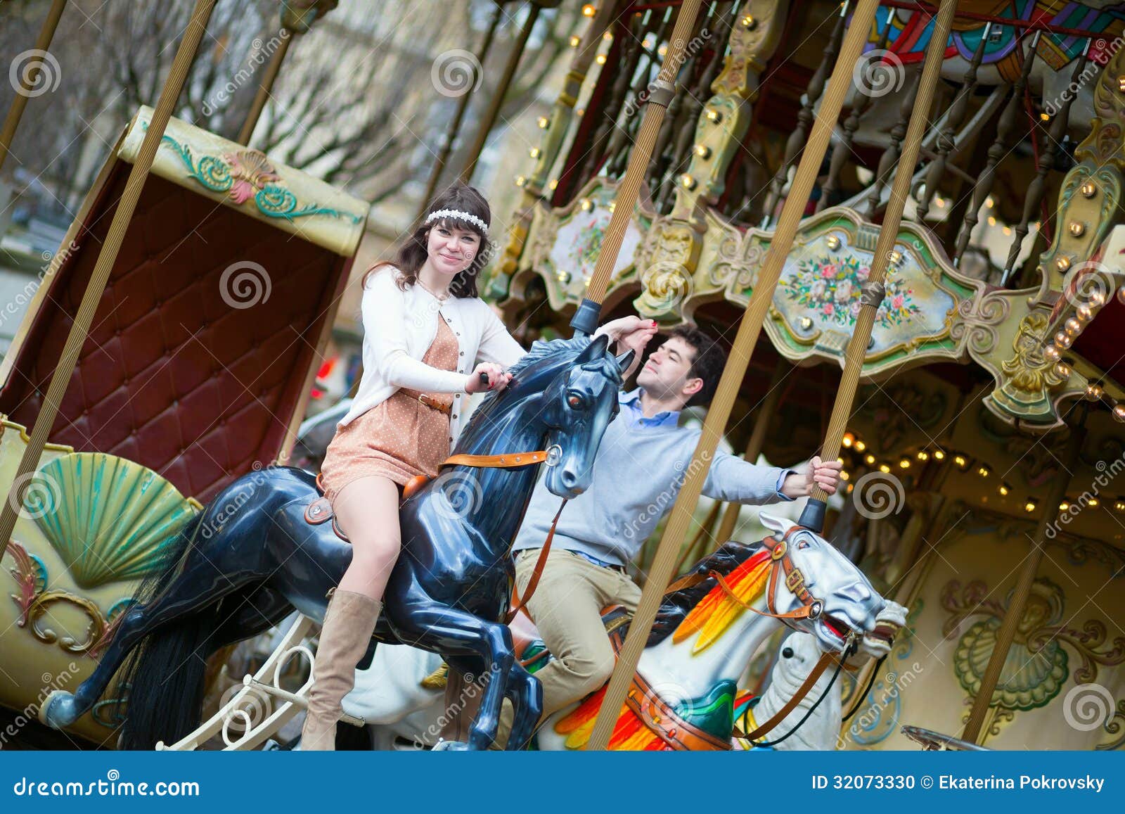Couple Having Fun on Merry-go-round Stock Photo - Image of outdoors ...