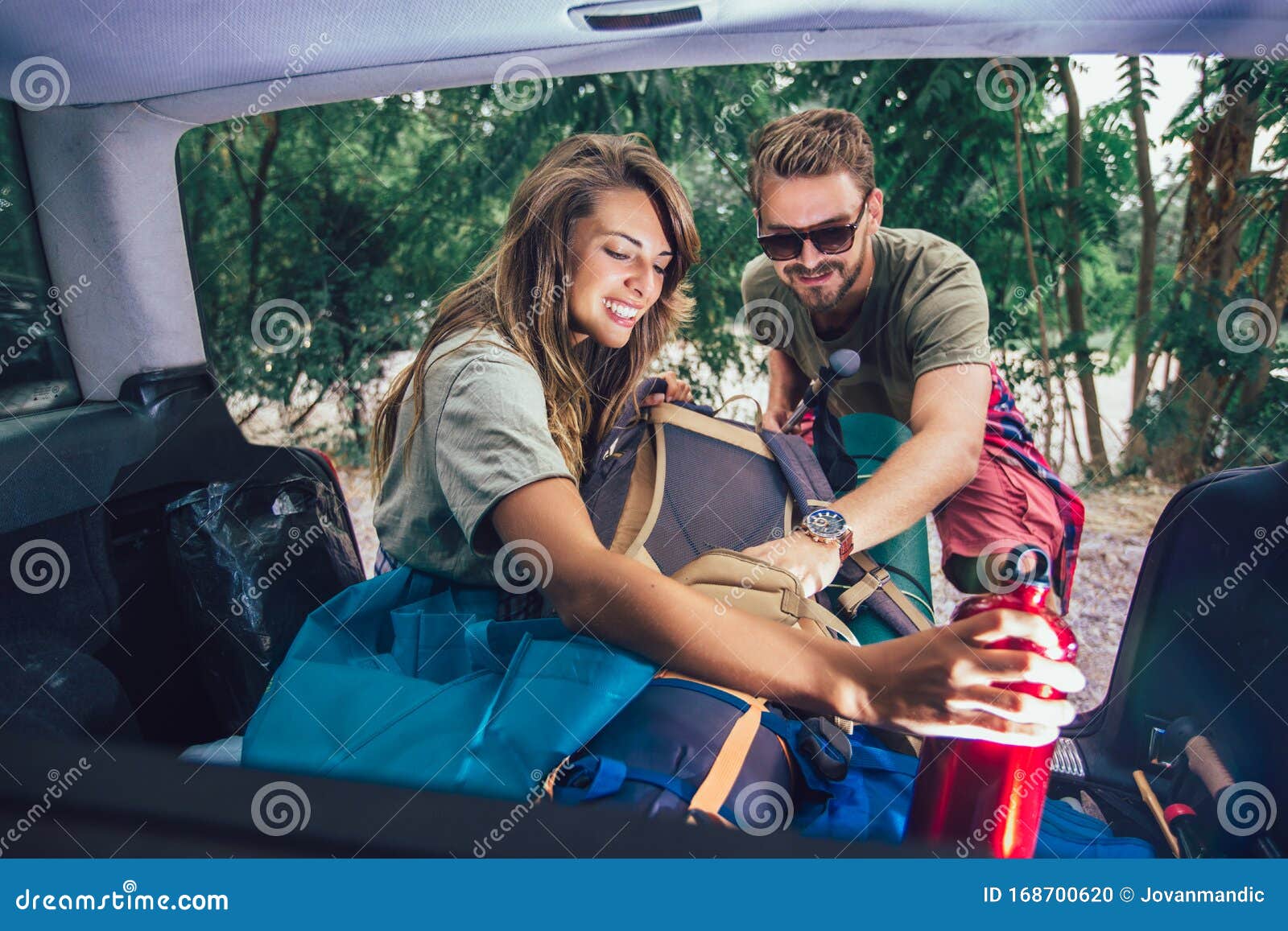 Couple Having Fun while Unpacking Camping Equipment Stock Photo - Image ...