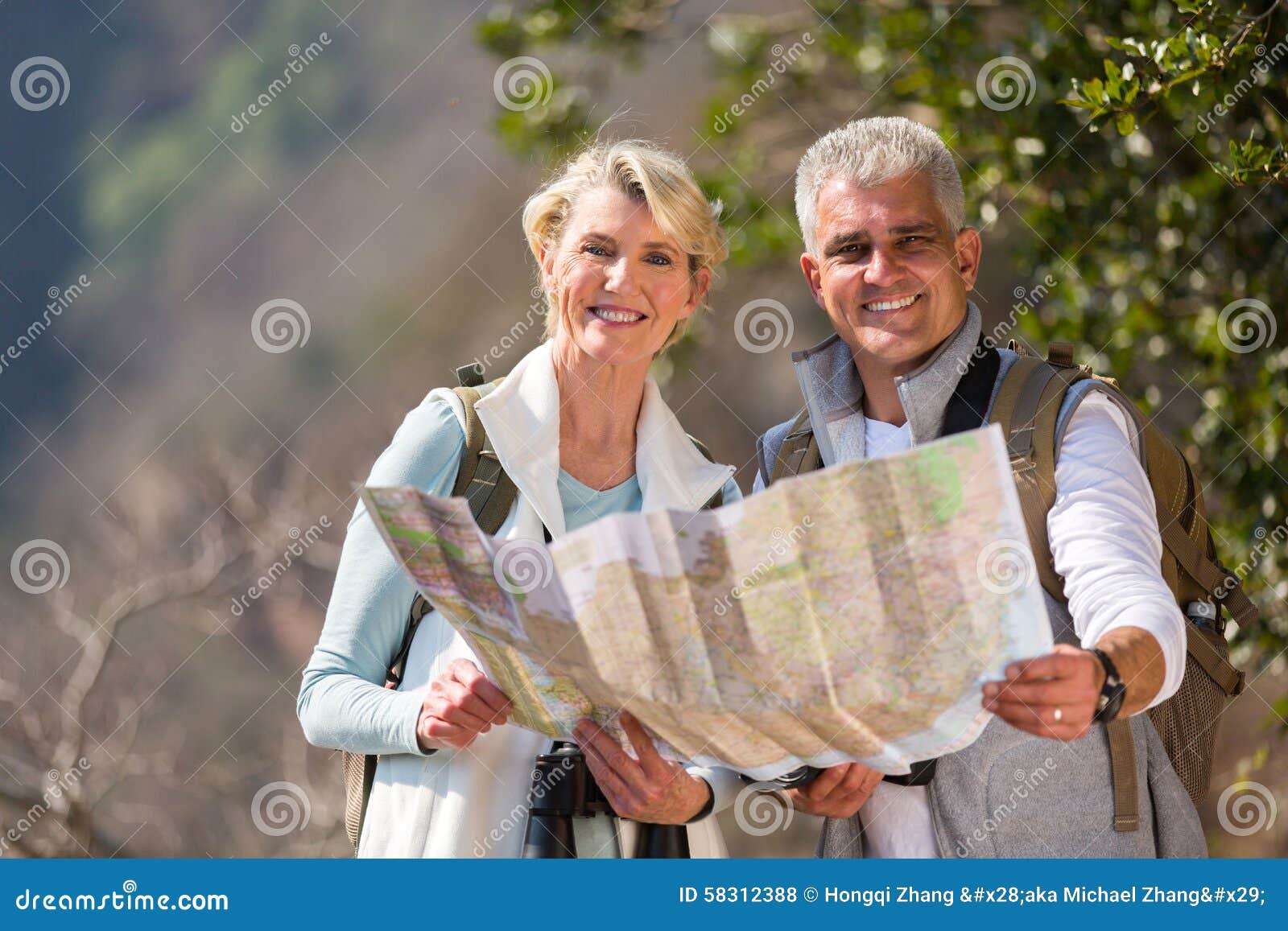 Couple hikers holding map stock photo. Image of female - 58312388