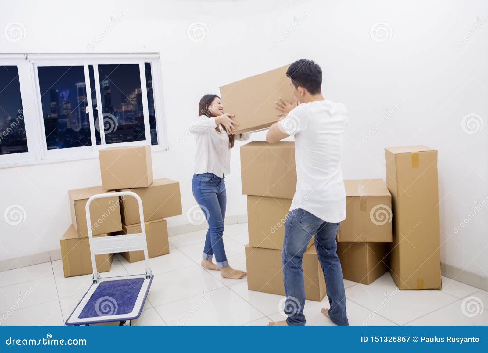 Couple Holding A Cardboard Box In New Apartment Stock Image Image Of