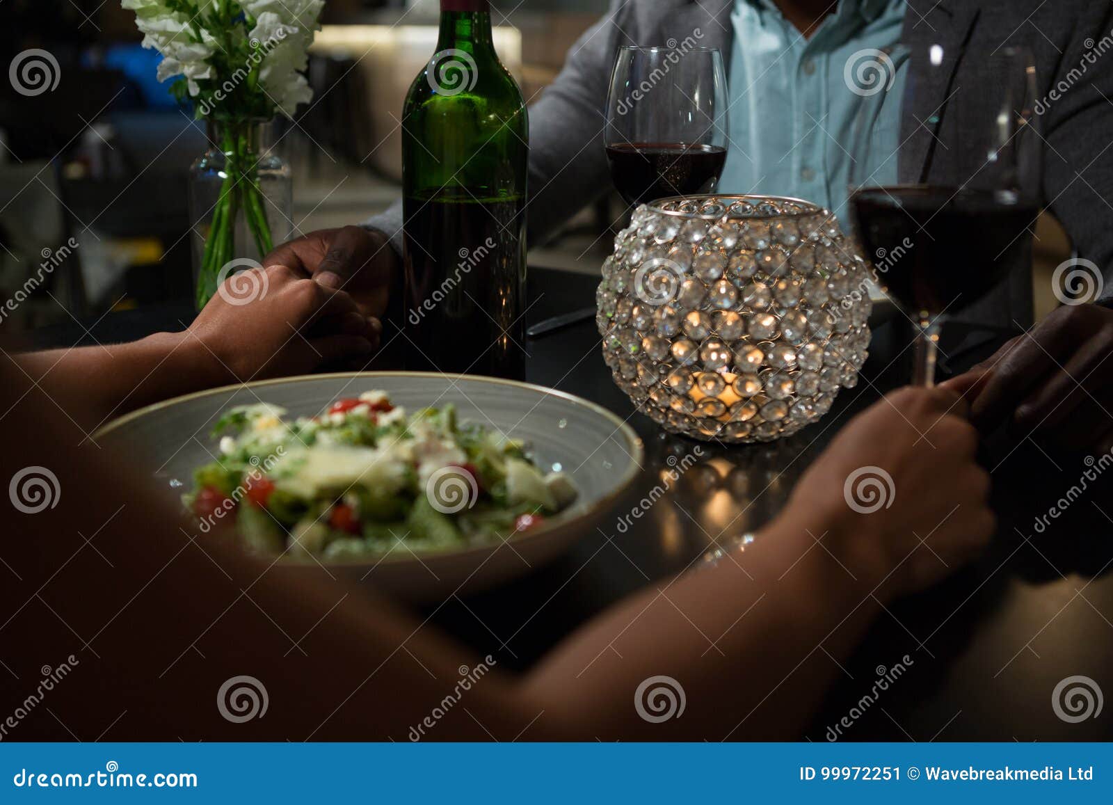 Couple Holding Hands while Dining at Table Stock Image - Image of ...