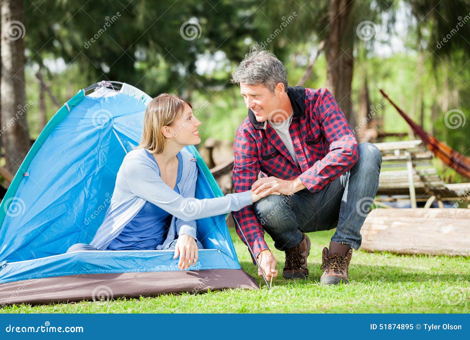Couple Holding Hands while Setting Up Tent in Park Stock Image - Image ...