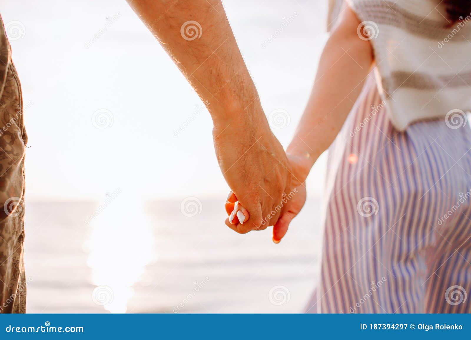 Couple Holding Hands At Sunset On Beach Romantic Man And Woman