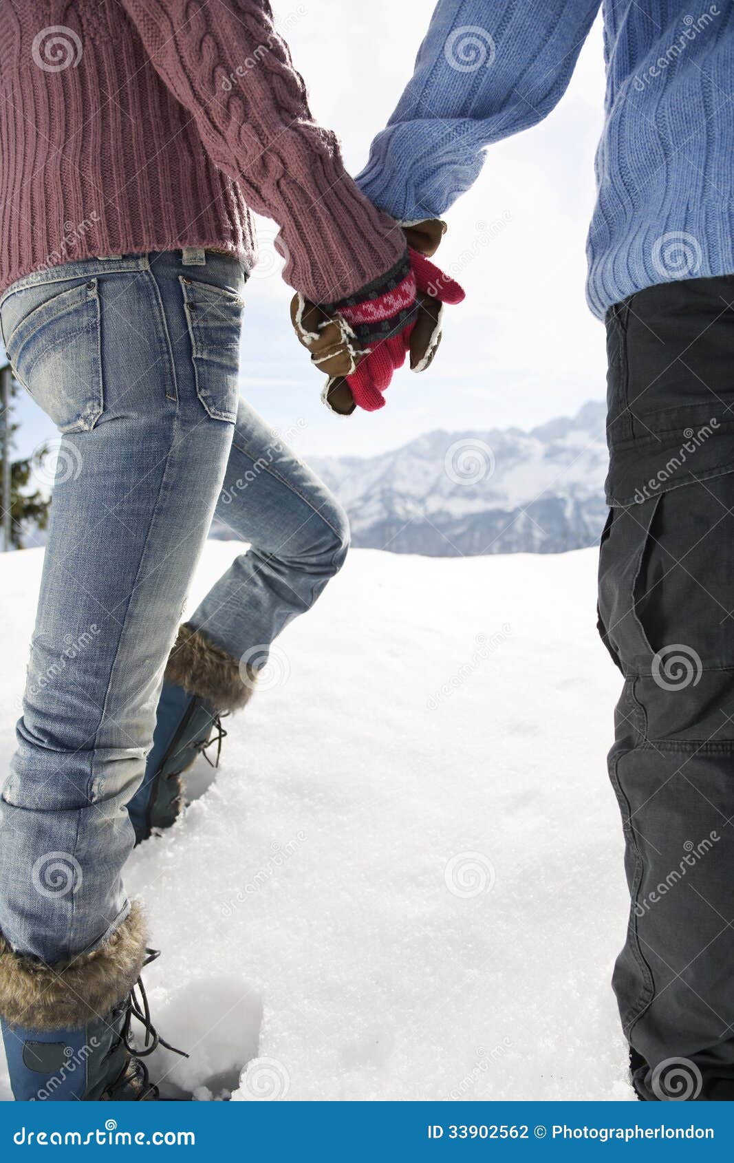 Couple Holding Hands and Walking through Snow Stock Photo - Image of ...