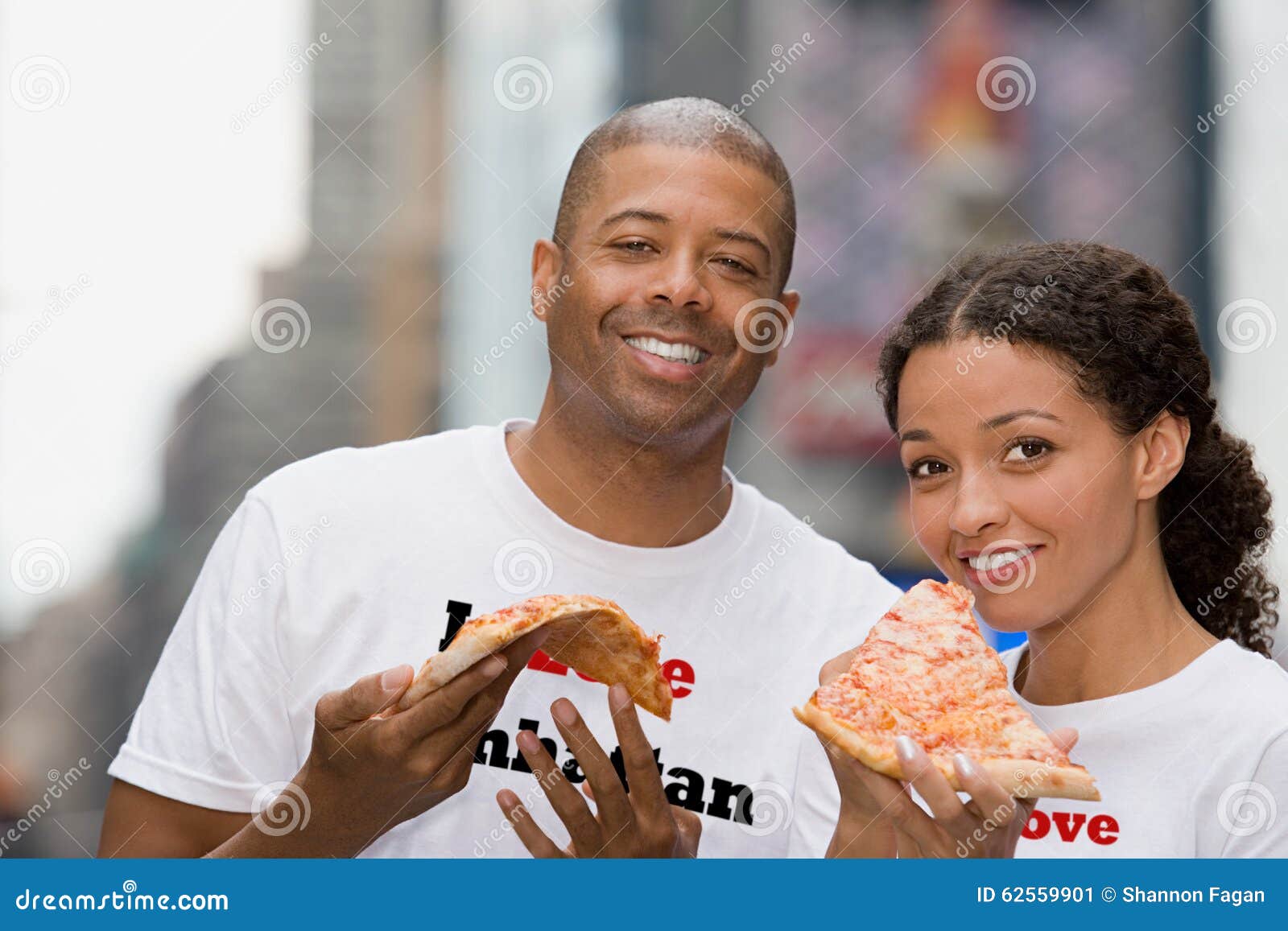Couple holding pizza stock image. Image of ethnicity - 62559901