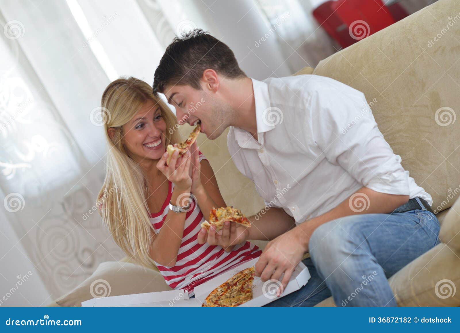 Couple at Home Eating Pizza Stock Photo - Image of looking, dining ...