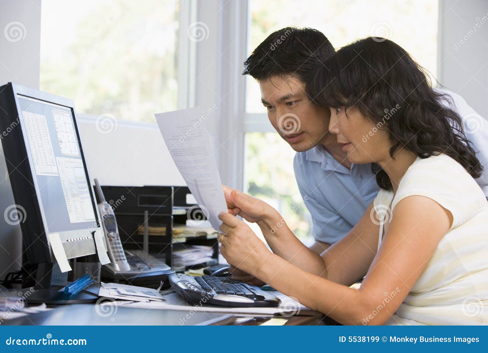 Couple in Home Office with Computer and Paperwork Stock Image - Image ...