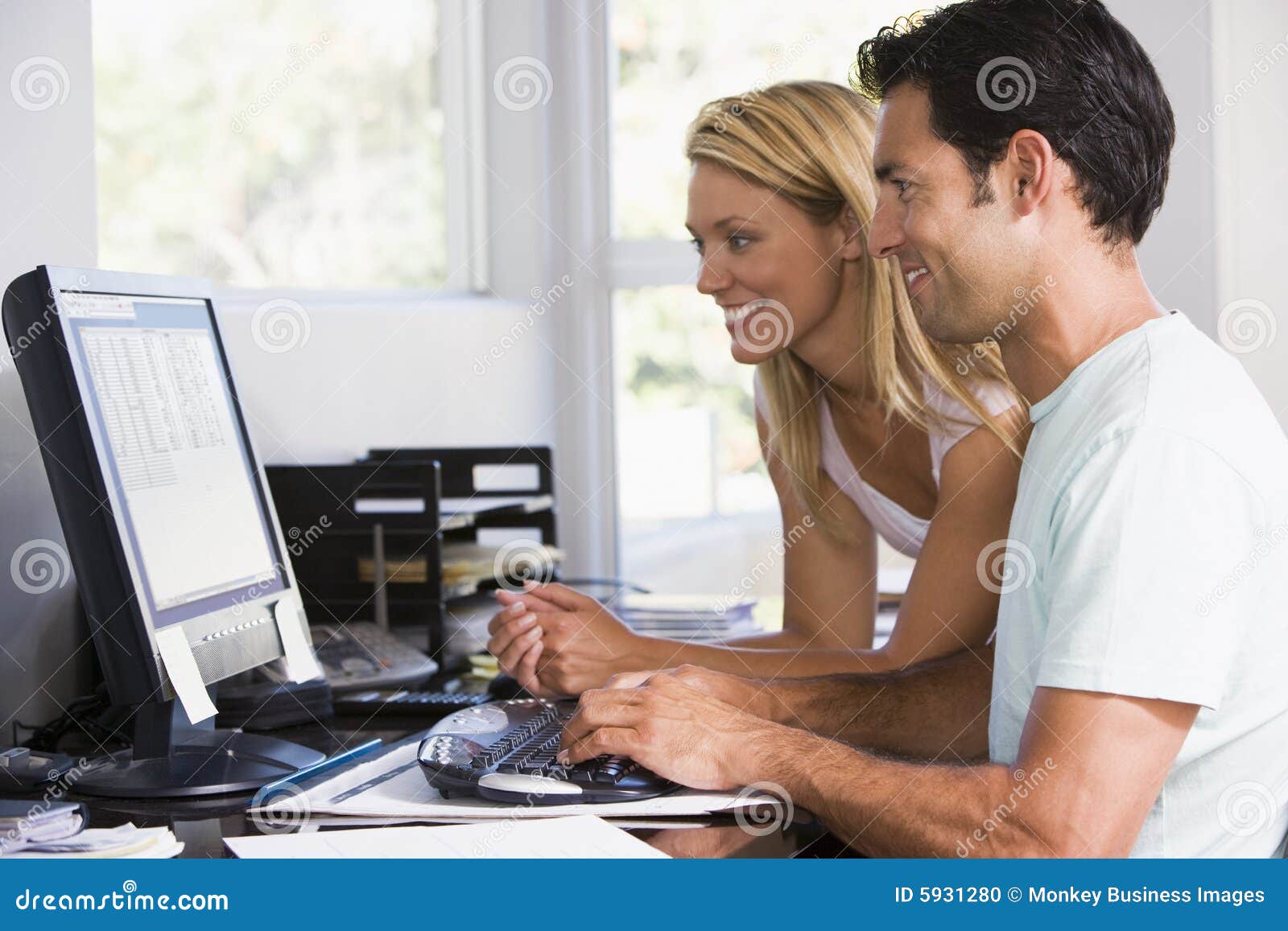 Couple in Home Office Using Computer and Smiling Stock Photo - Image of ...