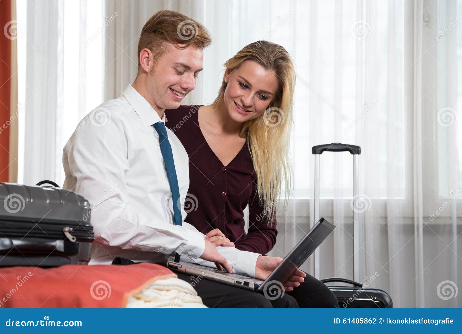 Couple in a Hotel Room Looking at Laptop Computer Stock Photo - Image ...