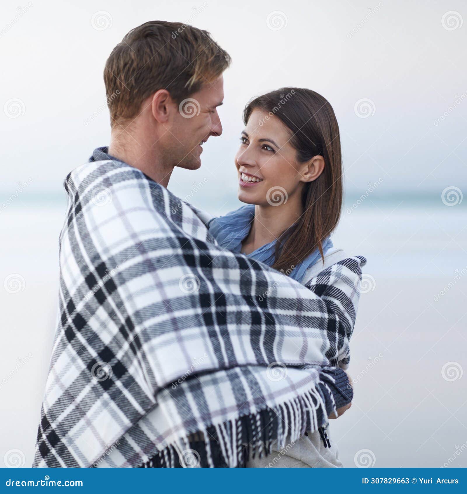 Couple Hug And Smile At Beach With Blanket For Vacation Love And Care