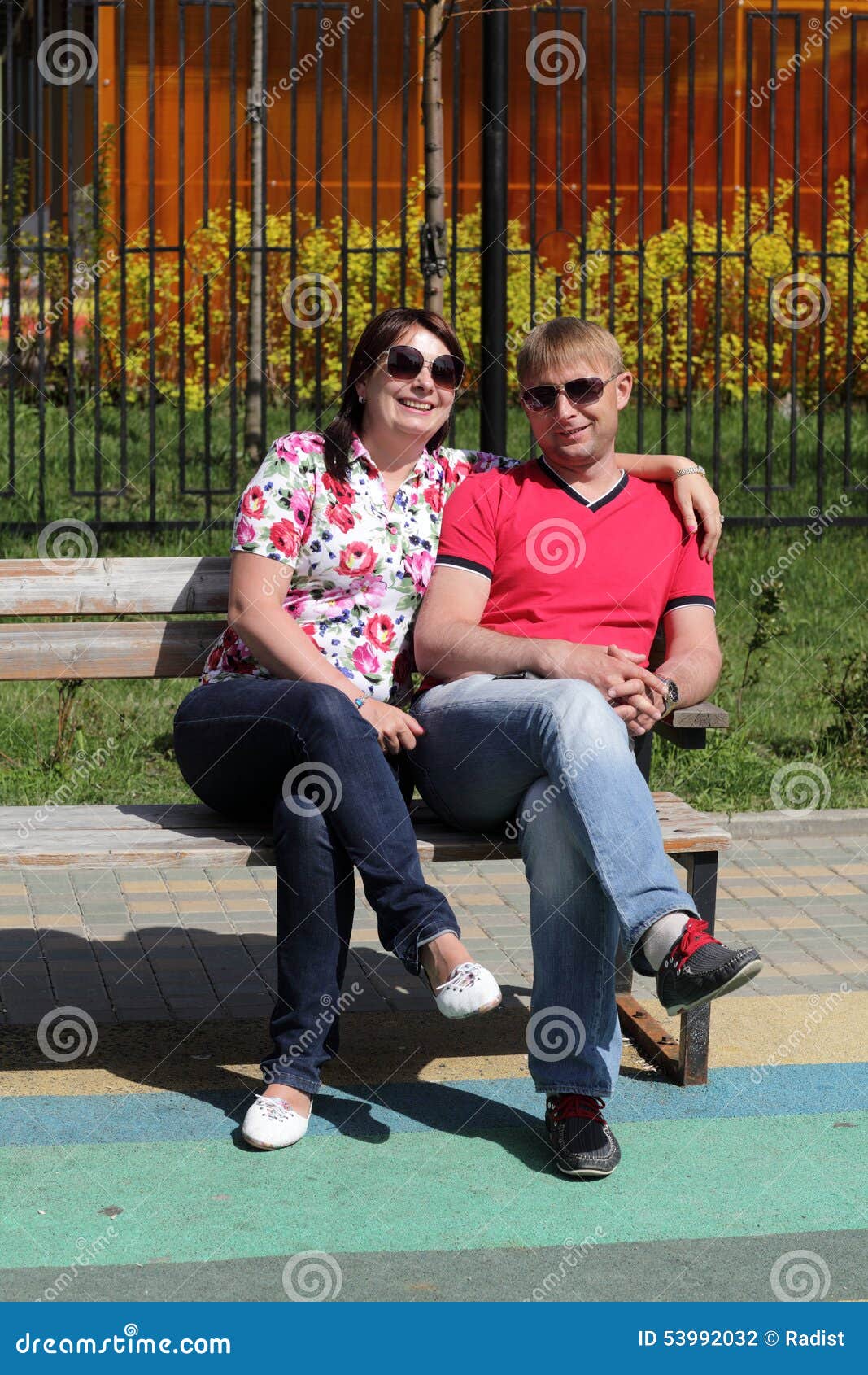 Couple hugging on a bench stock photo. Image of culture - 53992032
