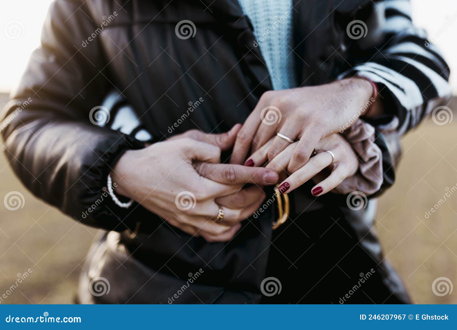 Couple Hugging and Holding Hands with Engagement Rings Stock Image ...