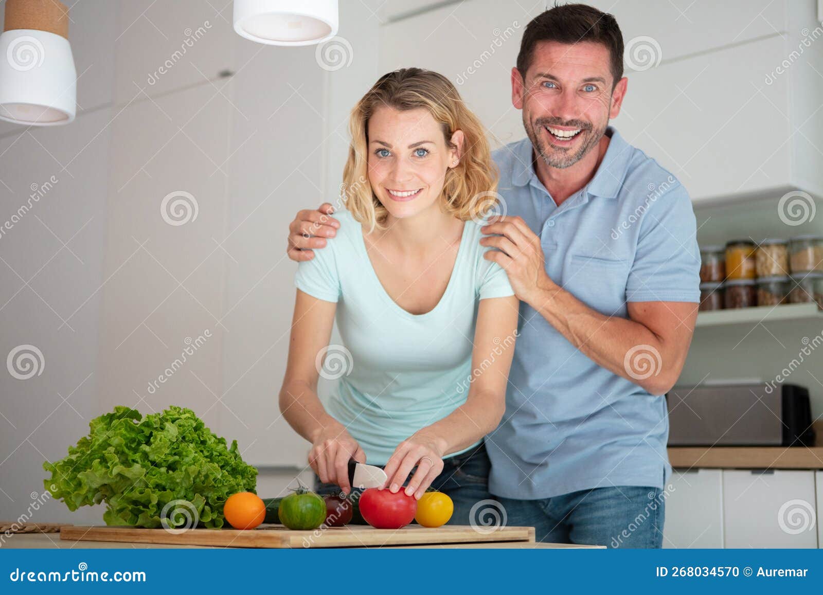 Couple Hugging in Kitchen while Cooking Stock Photo - Image of people ...
