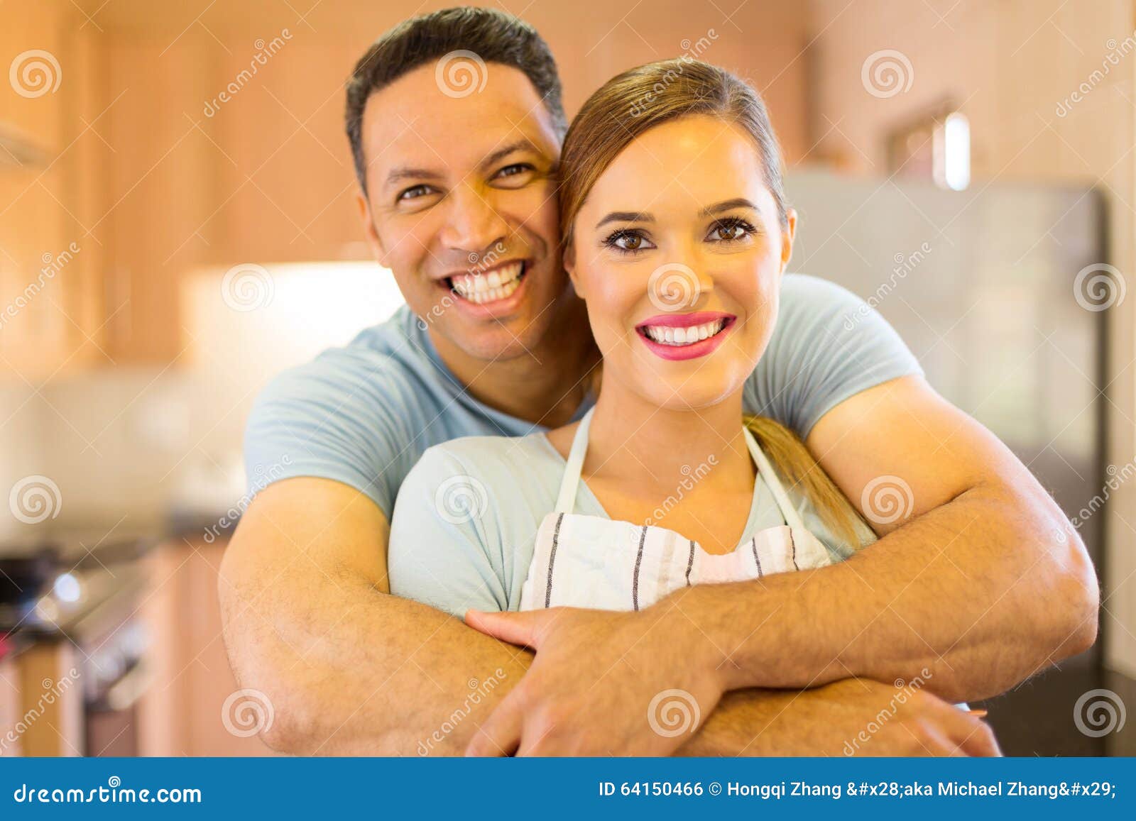 Couple hugging in kitchen stock photo. Image of house - 64150466