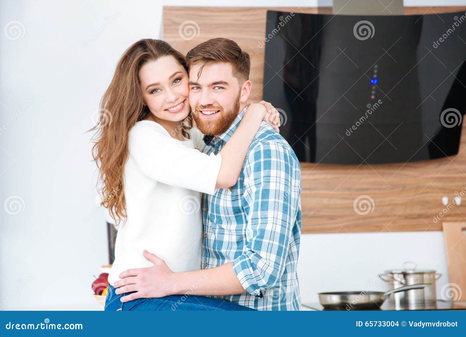 Couple Hugging and Looking at Camera Stock Photo - Image of casual ...