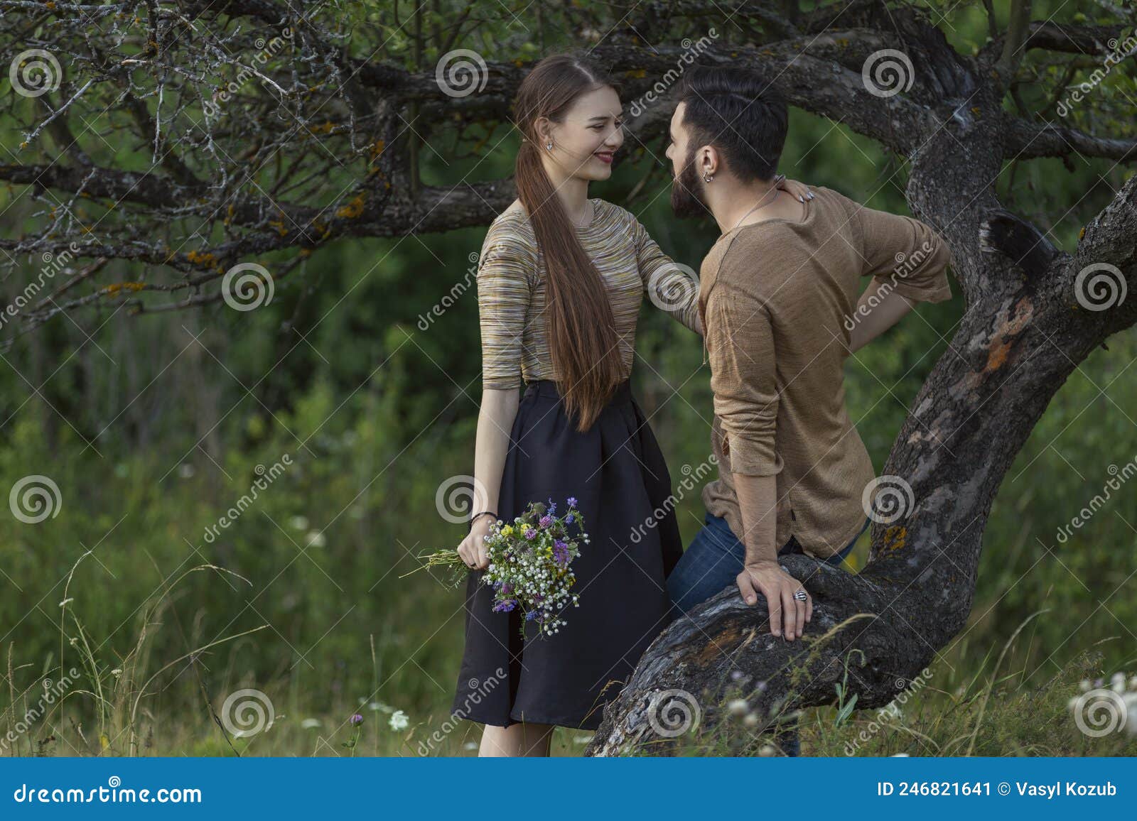 Couple hugging near a tree stock image. Image of embrace - 246821641