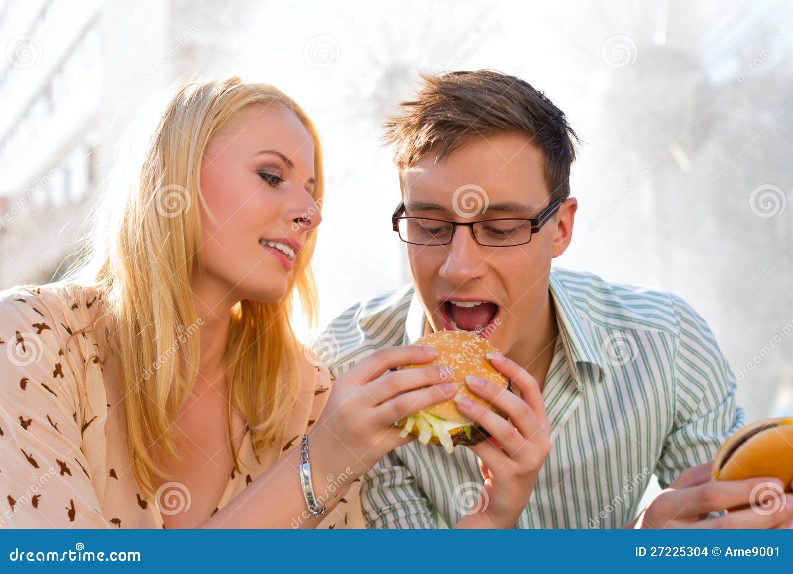 Couple is Hungry and Eating a Burger at Break Stock Photo - Image of ...