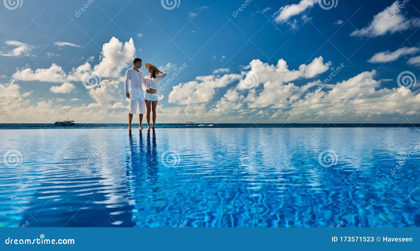 Couple at Infinity Pool Poolside Stock Image - Image of sunbath ...