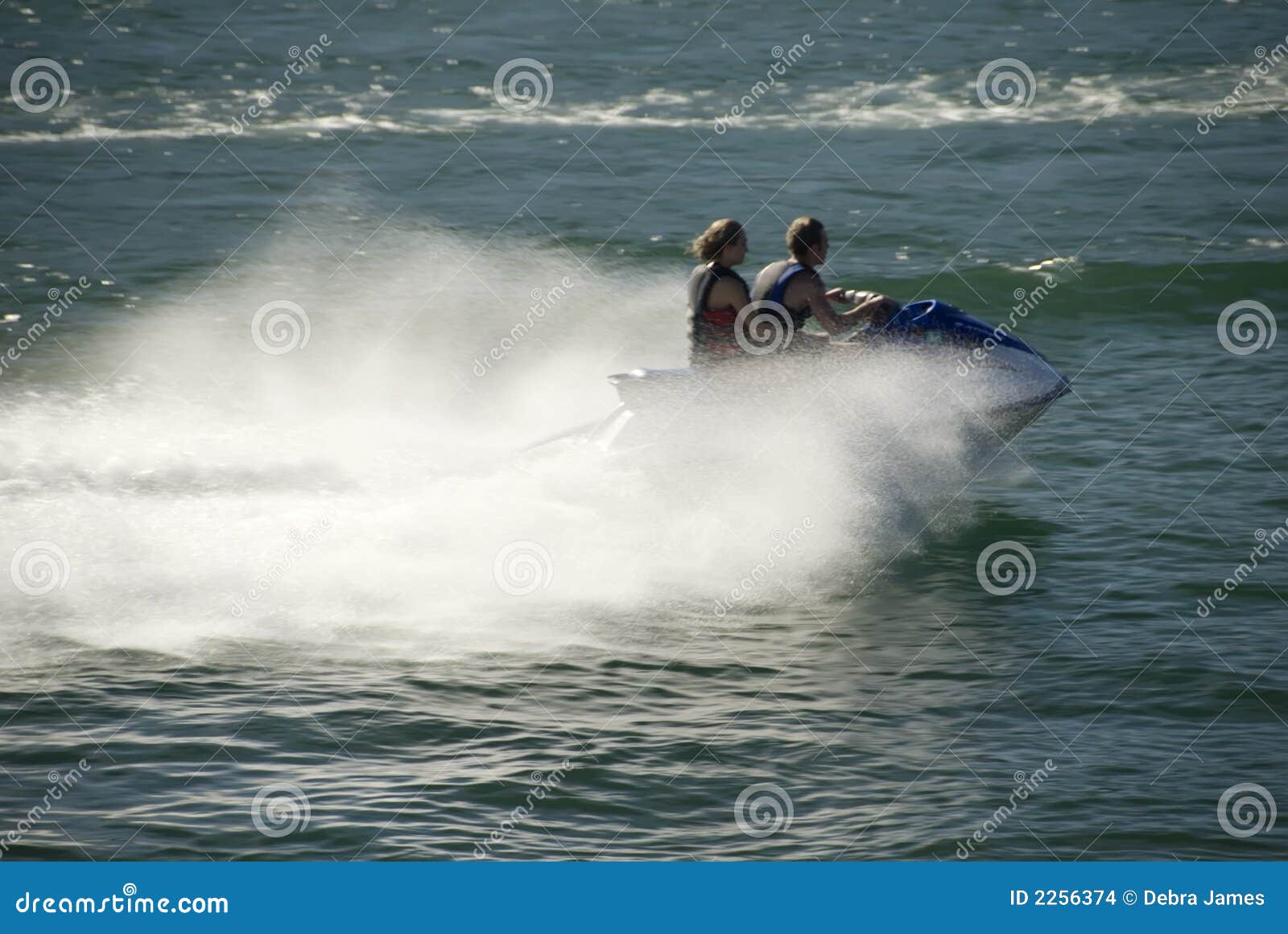 Couple on Jet Ski on Blue-green Water Stock Photo - Image of splash ...
