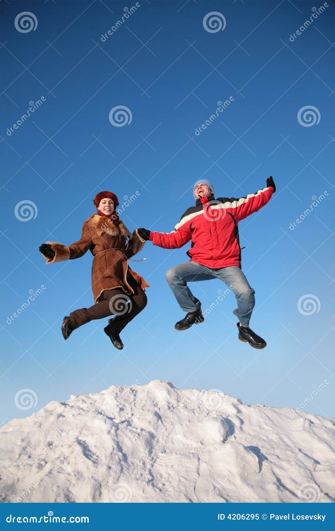 Couple Jump on Top of Snow Hill Stock Image - Image of coat, daylight ...