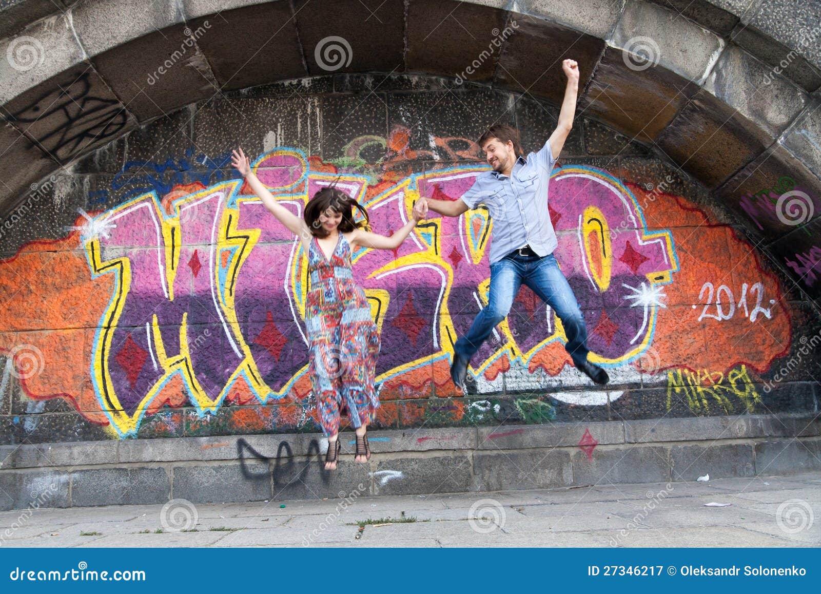 Couple Jumping Off the Ledge Editorial Photography - Image of graffiti ...