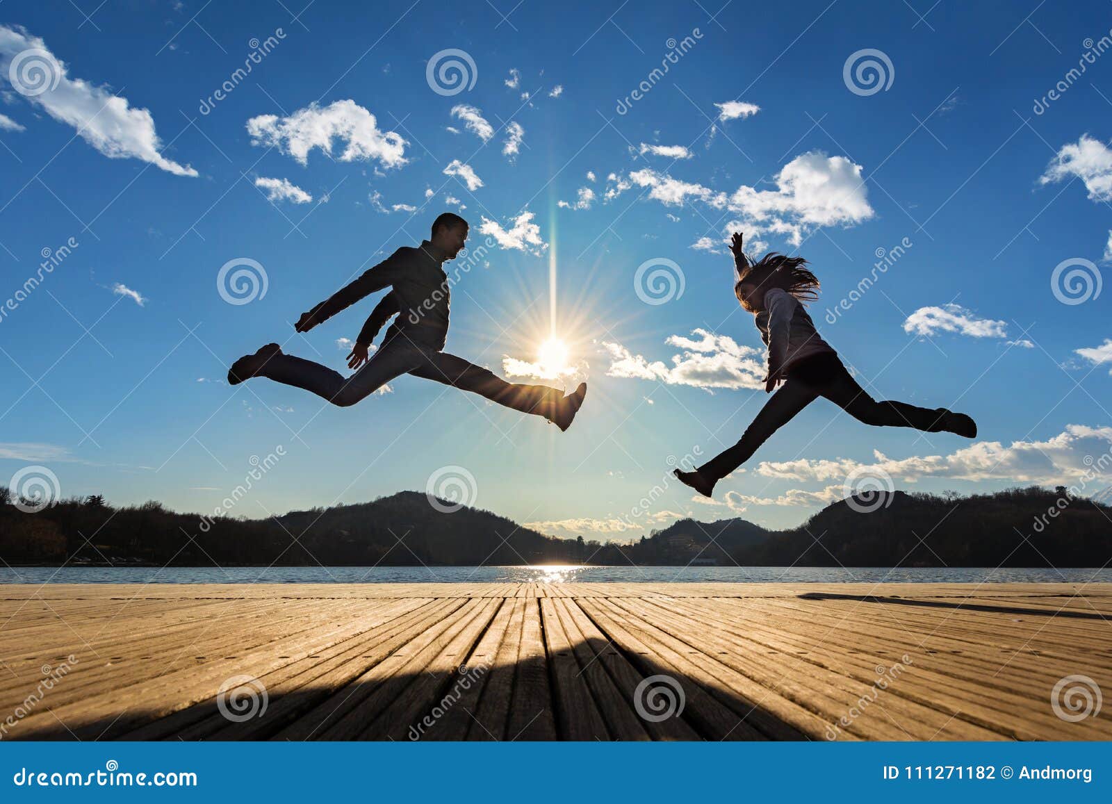 Couple jumping in the sun stock photo. Image of leap - 111271182