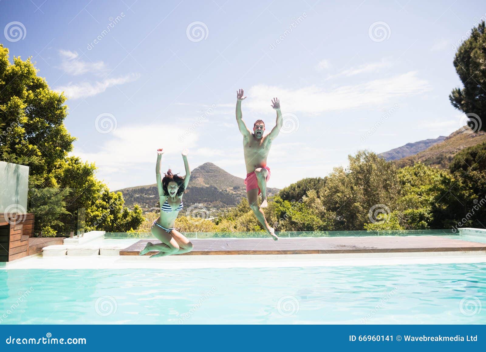 Couple Jumping into Swimming Pool Stock Image - Image of excited ...