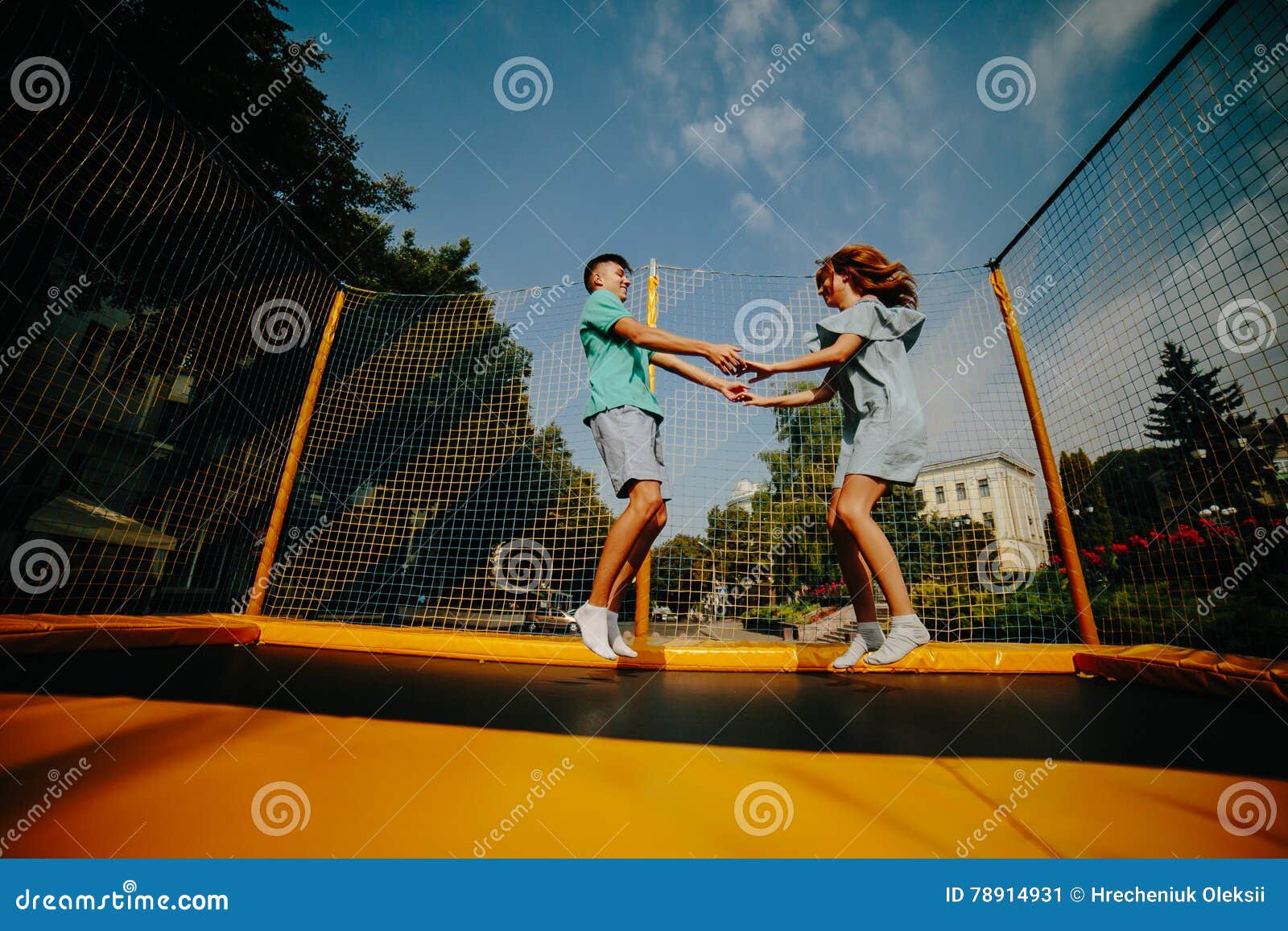 Couple Jumping on Trampoline in the Park Stock Image - Image of park ...