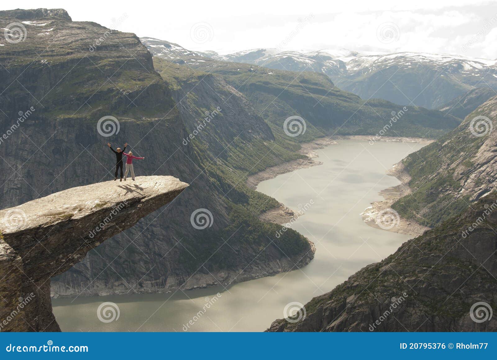 Couple Jumping on Troll S Tongue, Norway Stock Photo - Image of kick ...