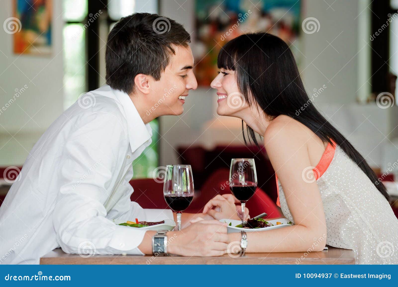 Couple Kiss Over Meal stock image. Image of inside, date - 10094937