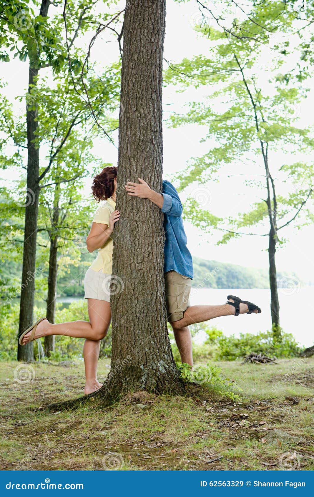 Couple Kissing Behind a Tree Stock Image - Image of people, park: 62563329