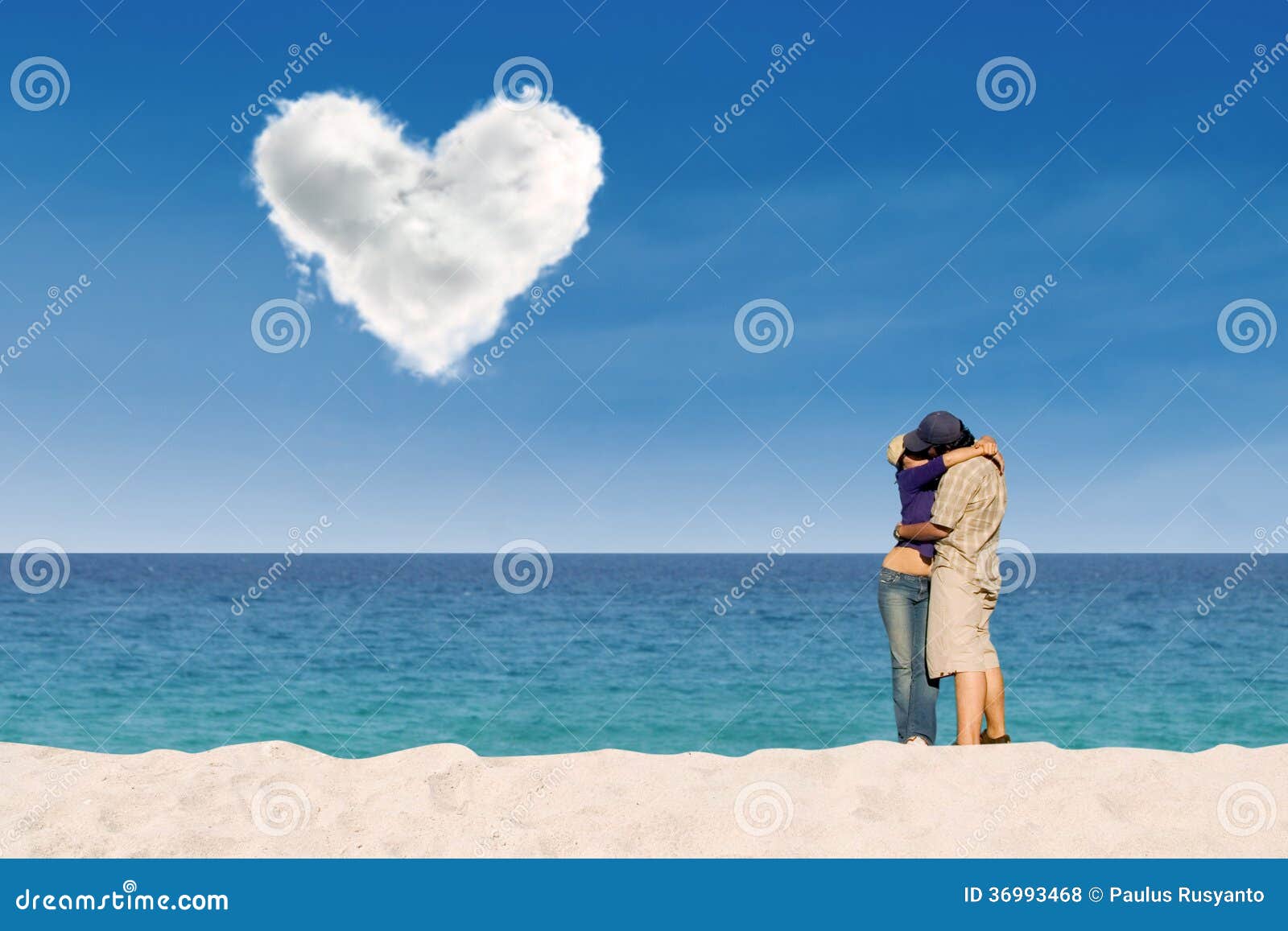 Couple Kissing Under Love Cloud at Beach Stock Photo - Image of blue ...