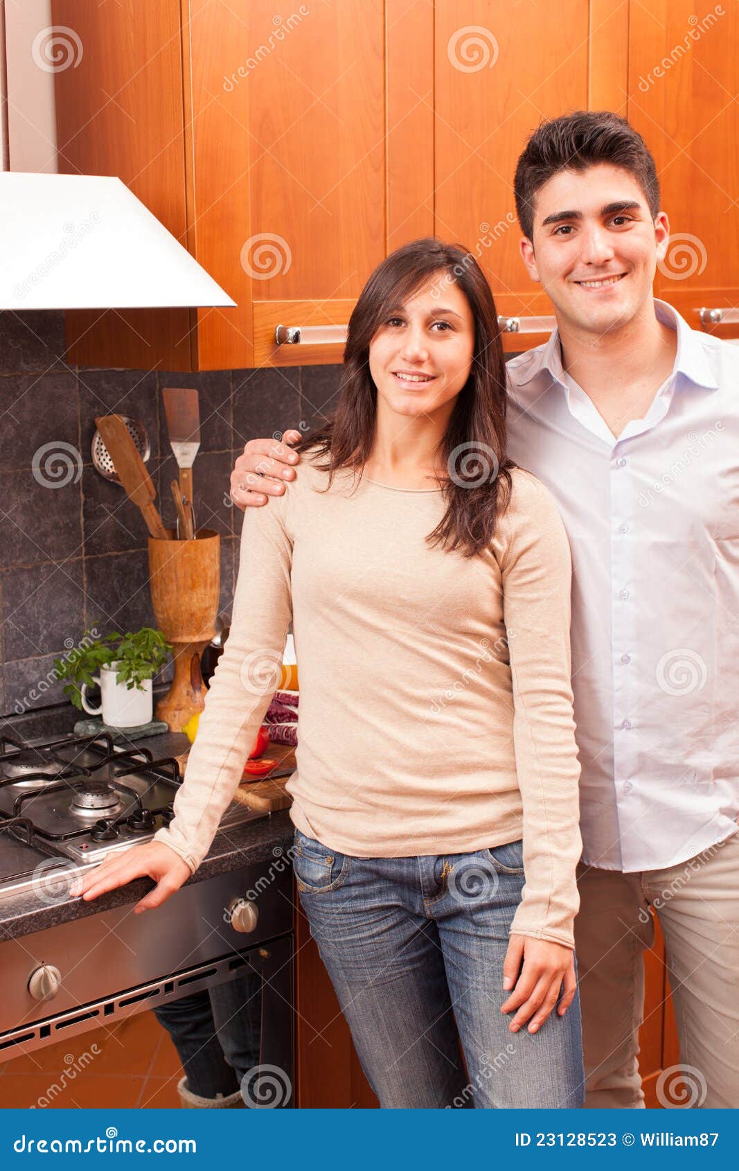 Couple in the Kitchen stock image. Image of embracing - 23128523