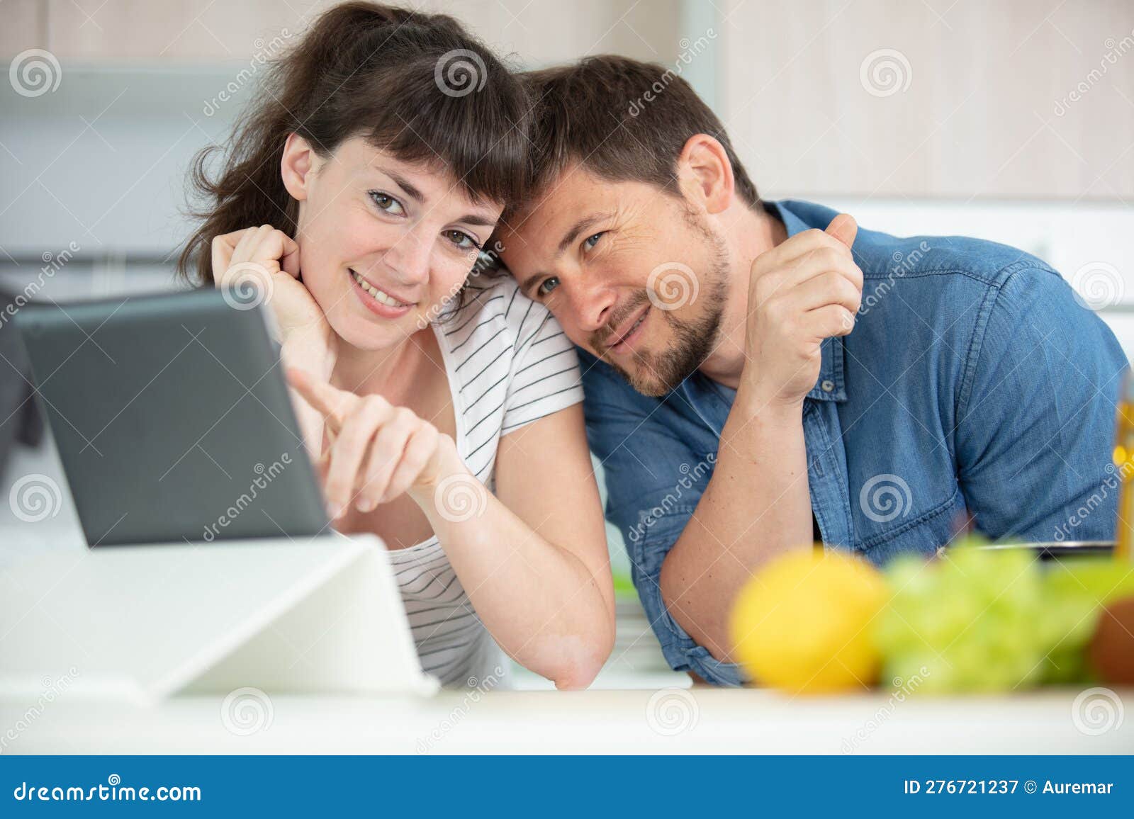 Couple in Kitchen Looking at Recipe on Tablet Stock Image - Image of ...
