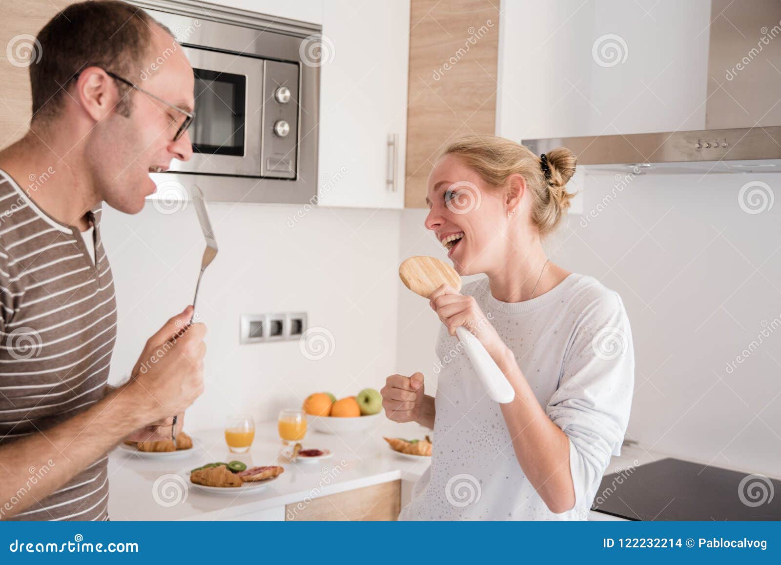 Couple in the Kitchen Singing and Laughing Stock Photo - Image of ...