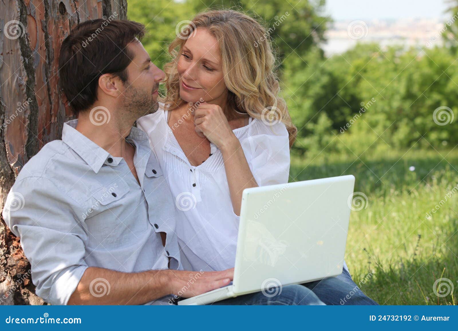 Couple with a Laptop Outside Stock Photo - Image of kiss, handsome ...
