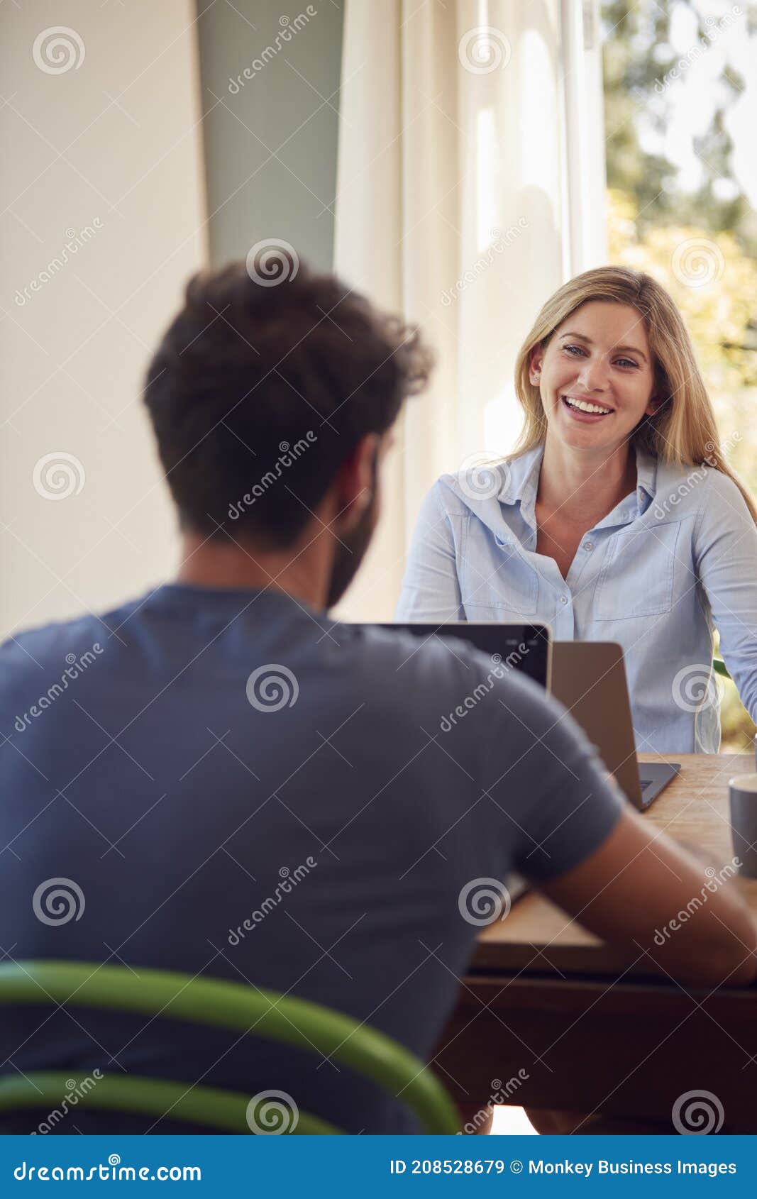 Couple with Laptop Sitting at Table Working from Home Together Stock ...